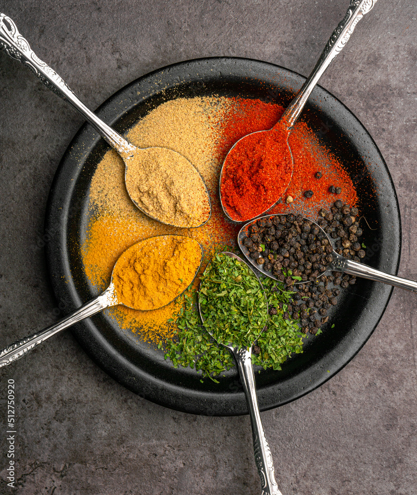 Assorted of colorful spices (red pepper powder, turmeric powder, black ...