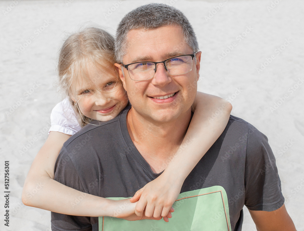 Daughter hugging her father on the beach Stock Photo | Adobe Stock
