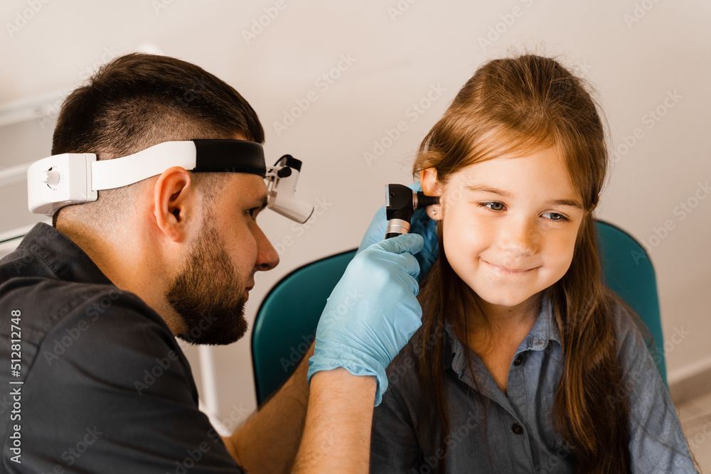 Otoscopy of child ears with otoscope. ENT doctor. Consultation with ...