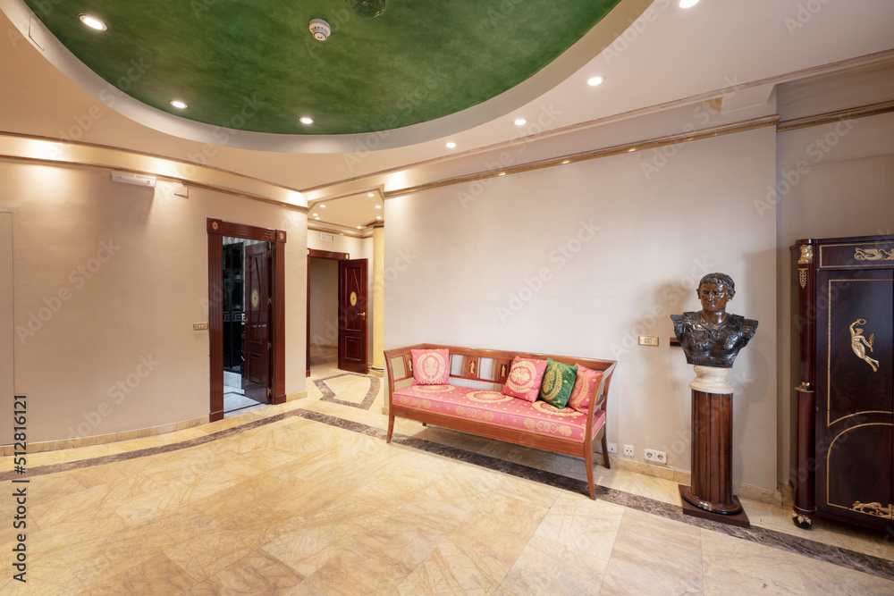 Distribution area of a professional office with a divan with cushions ...