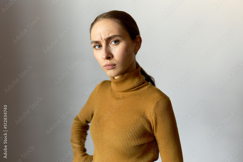 Portrait of pretty young woman standing against white background with ...