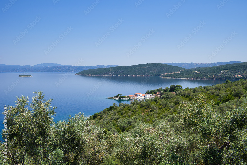 Wonderful Greek landscape, traditional house in front of a small bay ...