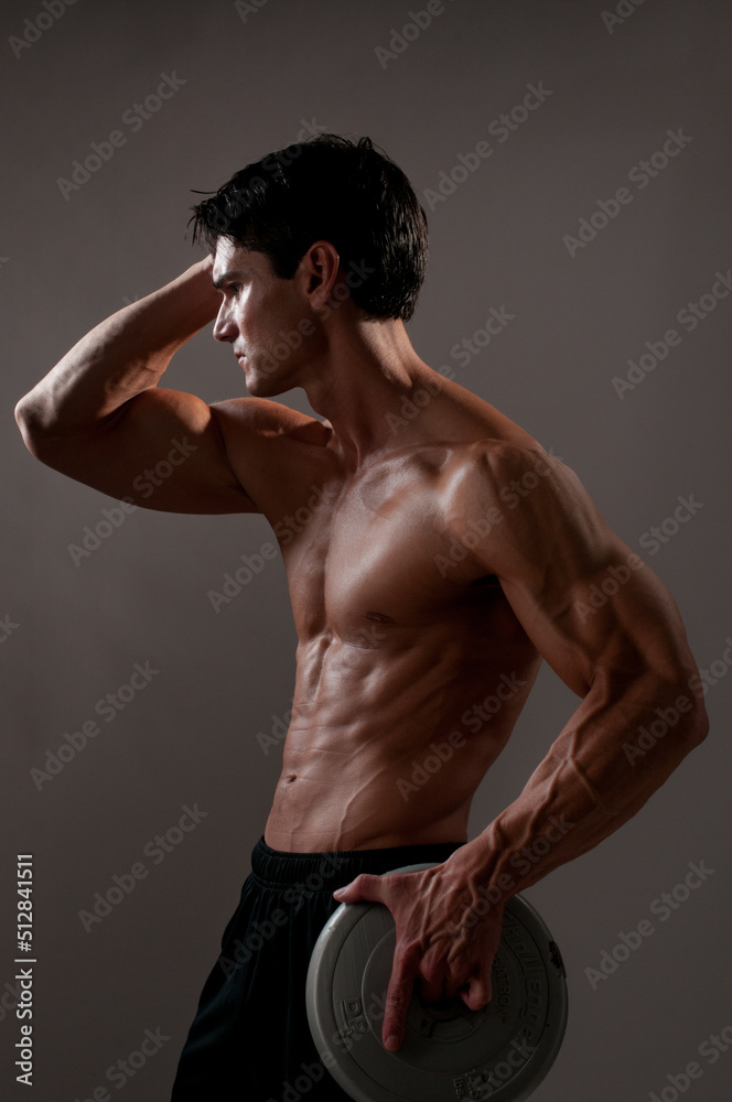 The muscular man poses for the exercise routine wearing a black pair of ...