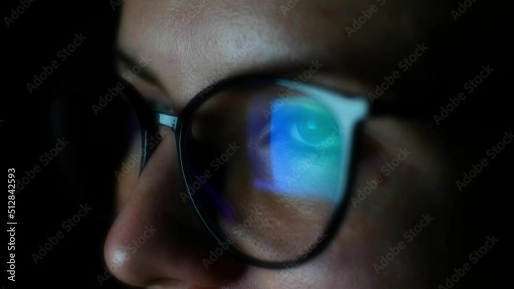 Girl works on internet. Reflection at the glasses from laptop. Close up ...