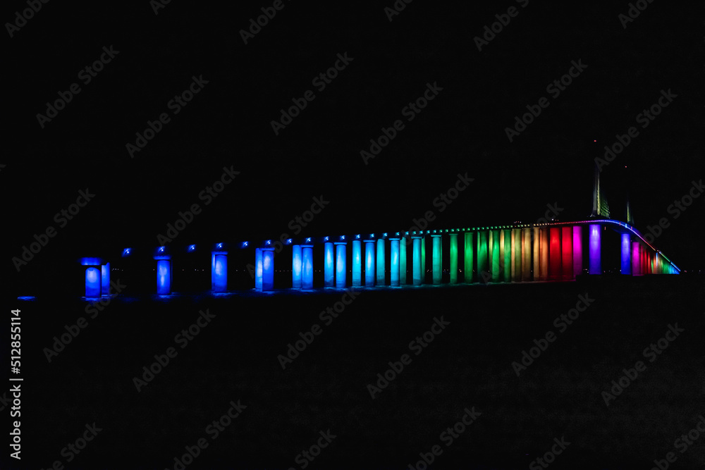 LGBTQ rainbow colors illuminate Skyway Bridge. Stock Photo | Adobe Stock