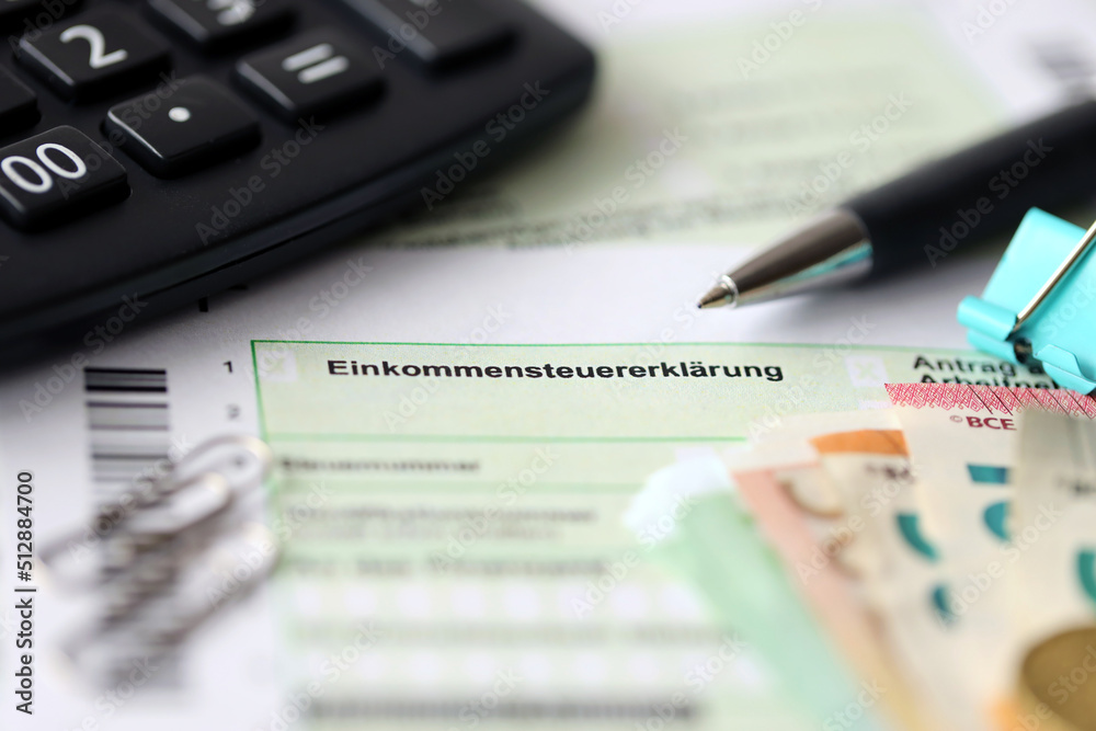 German income tax return form with pen and european euro money bills ...
