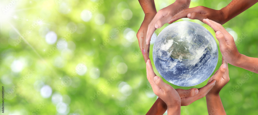 Conceptual symbol of multiracial human hands surrounding the Earth ...