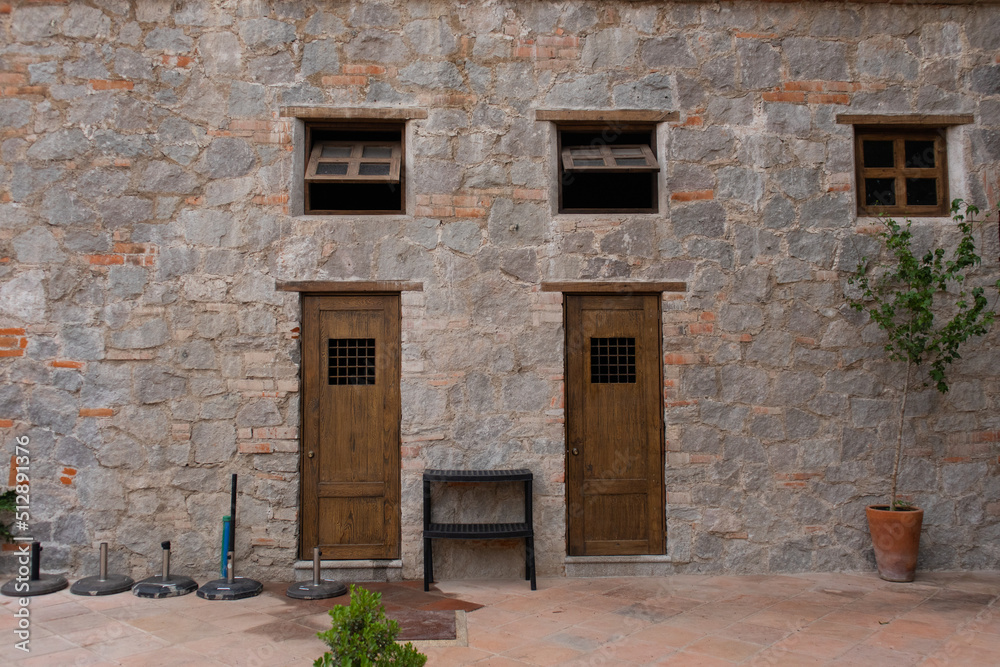 front facade of a medieval house with two wooden doors and two old ...