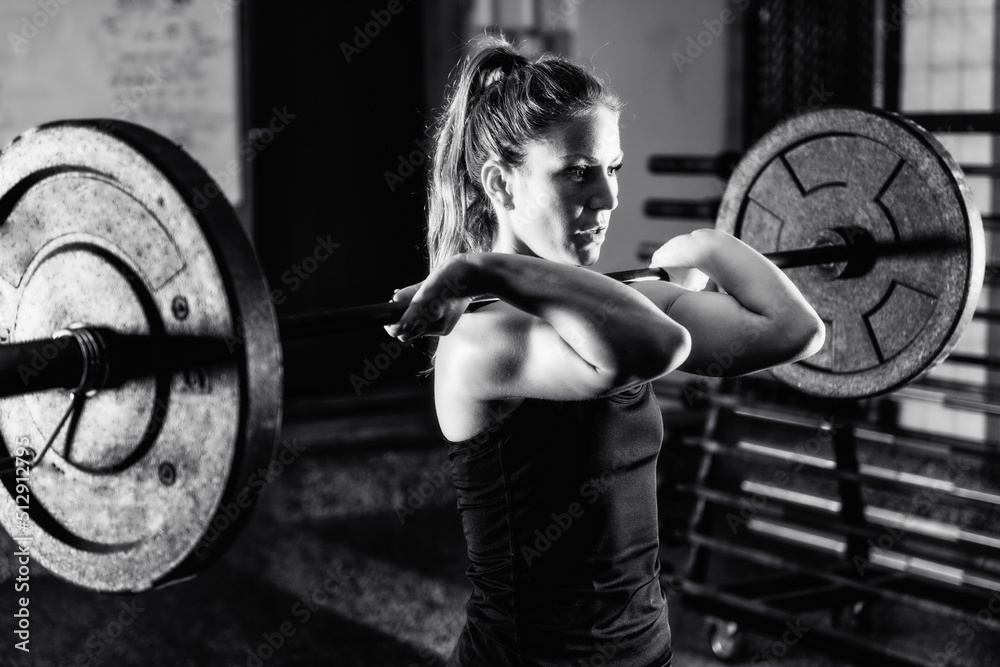 Cross training. Female athlete lifting heavy barbells Stock-Foto ...