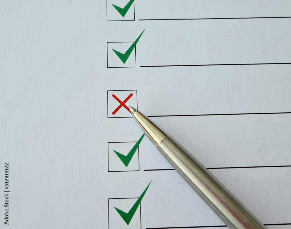 Check checklist of red and green marks with a pen Stock Photo | Adobe Stock