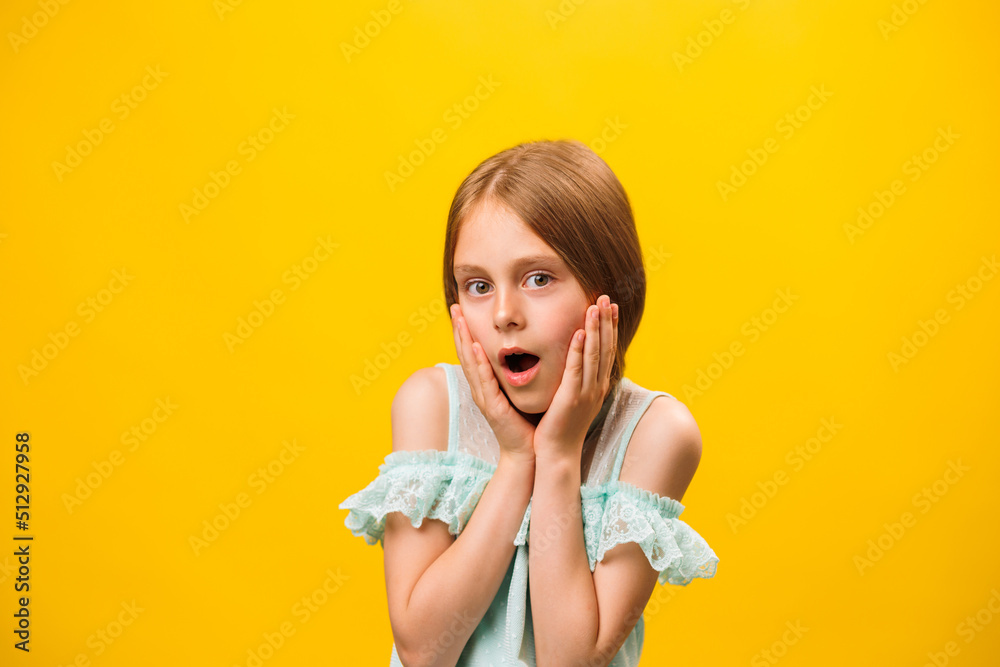 scared little american kid girl with her hands on her face and her ...