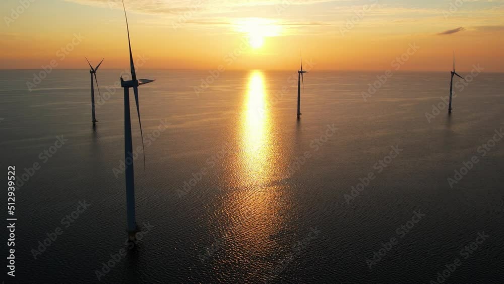 Working offshore wind farm, sunset view. Aerial view of wind turbines ...