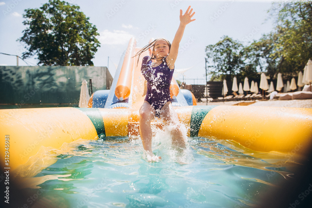 Little girl on water slide at aquapark during summer holiday Stock ...