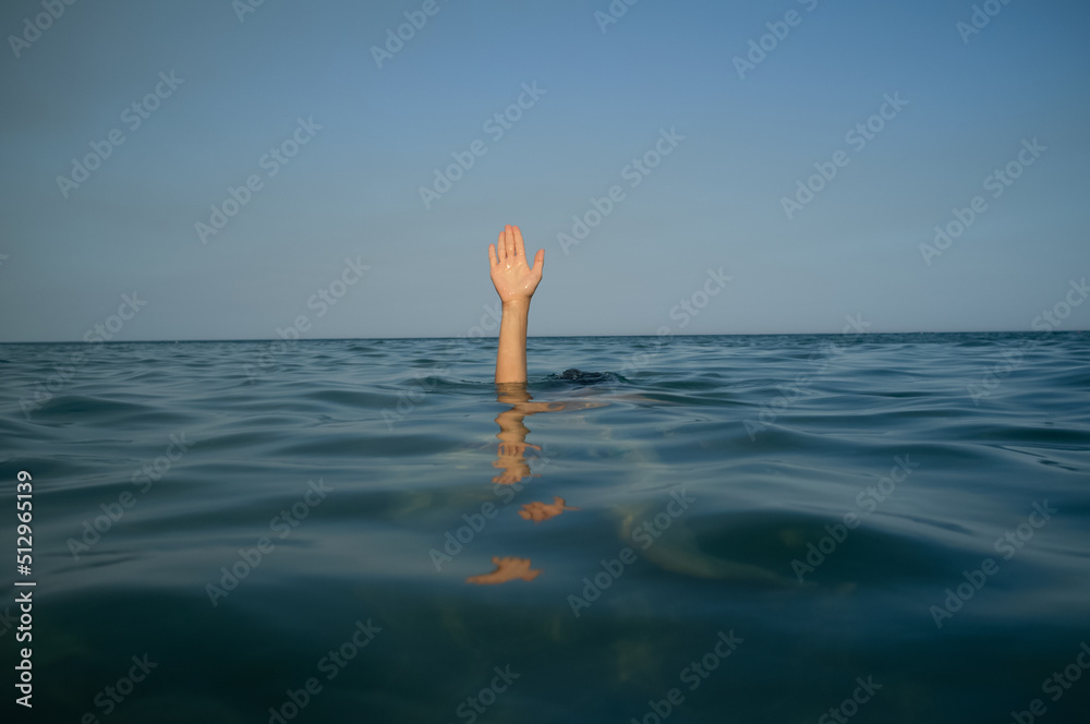 Man hand forearm coming out of water beach blue sea Stock Photo | Adobe ...