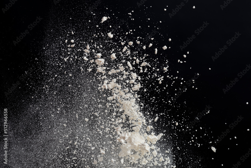 Foto de Flying white flour, powder on a black background. Spray of ...