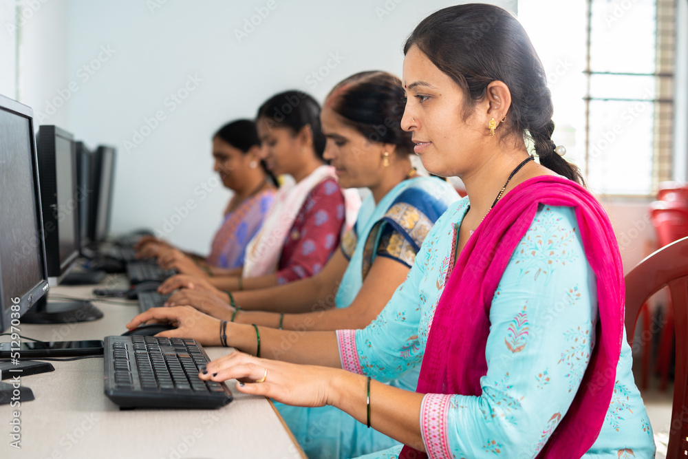 group of women busy learning or working on computer at training center ...
