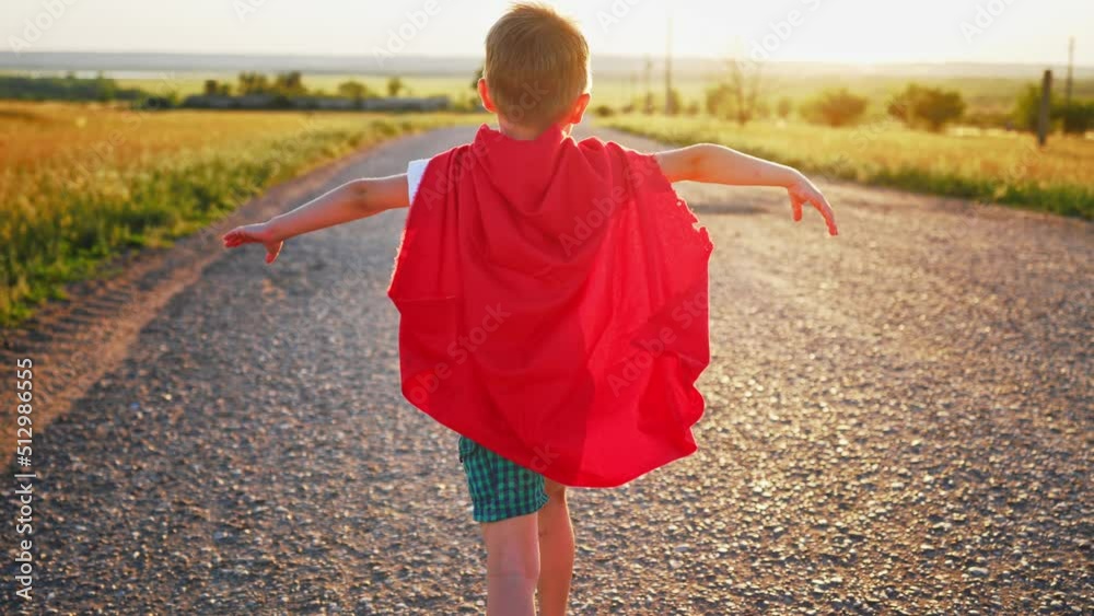 Boy Plays Superhero. Happy little boy are playing superhero. Kid run ...