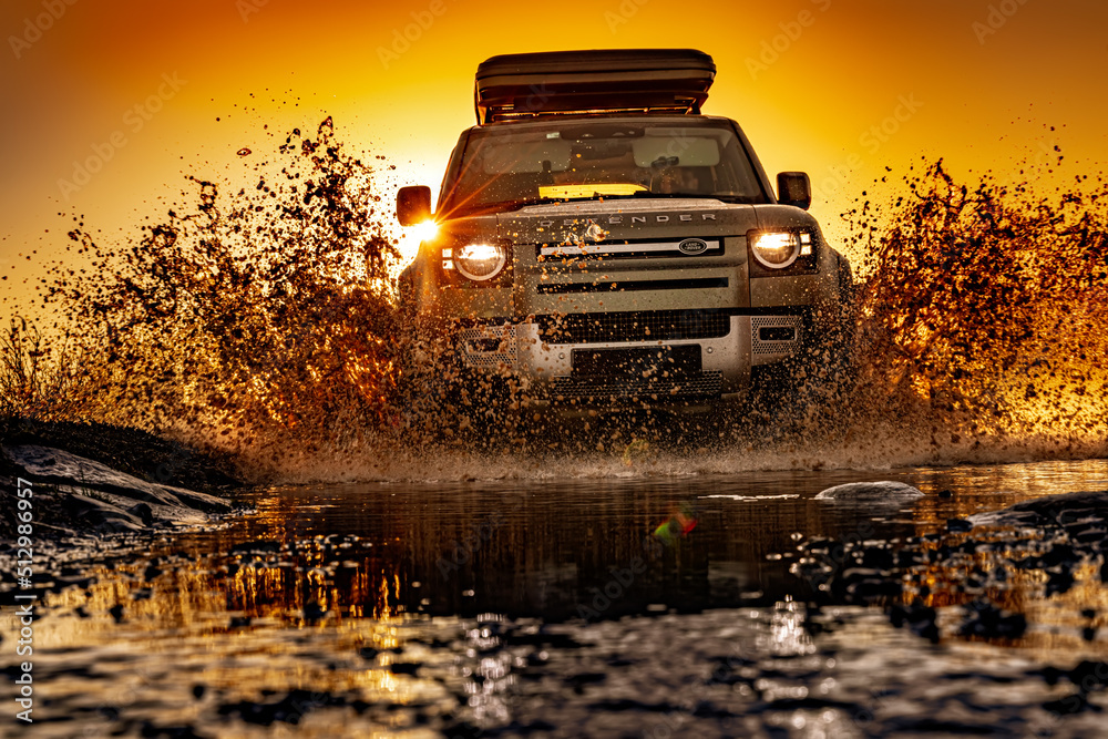 Rybachy, RUSSIA - May 30 2022: Off-roading New Land Rover Defender. The ...