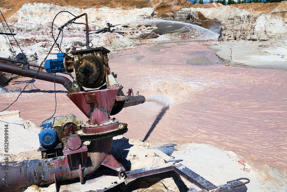 Foamy muddy water gushes out of the pipe under high pressure. Discharge ...