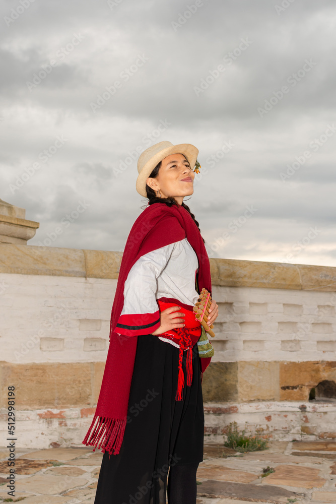 Latin American peasant woman in traditional dress standing while ...