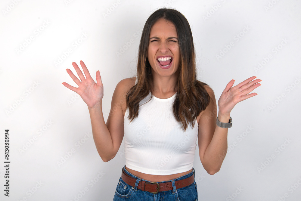 Crazy outraged young beautiful caucasian woman wearing white Top over ...