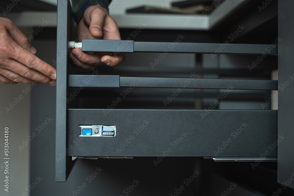 Furniture maker assembling new modern drawer system with adjustment ...