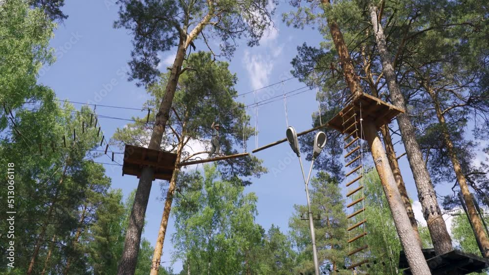 Brave teenage girl overcomes difficult obstacles while walking along a ...