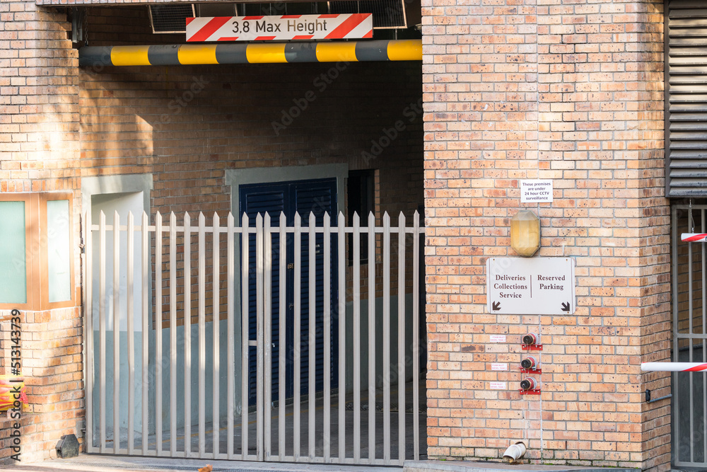 parking garage entrance with maximum height restrictions sign or ...