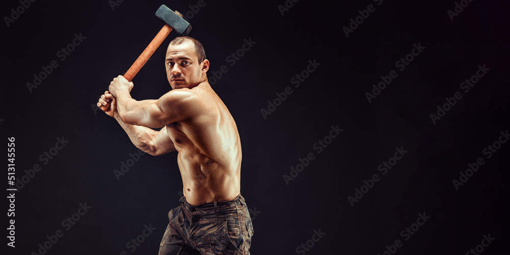 Muscular man with great anatomy posing on a black background with a big ...