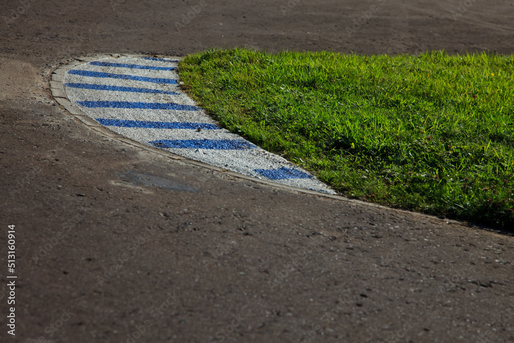 Curbstones of a racing track with some nice green grass on the inside ...