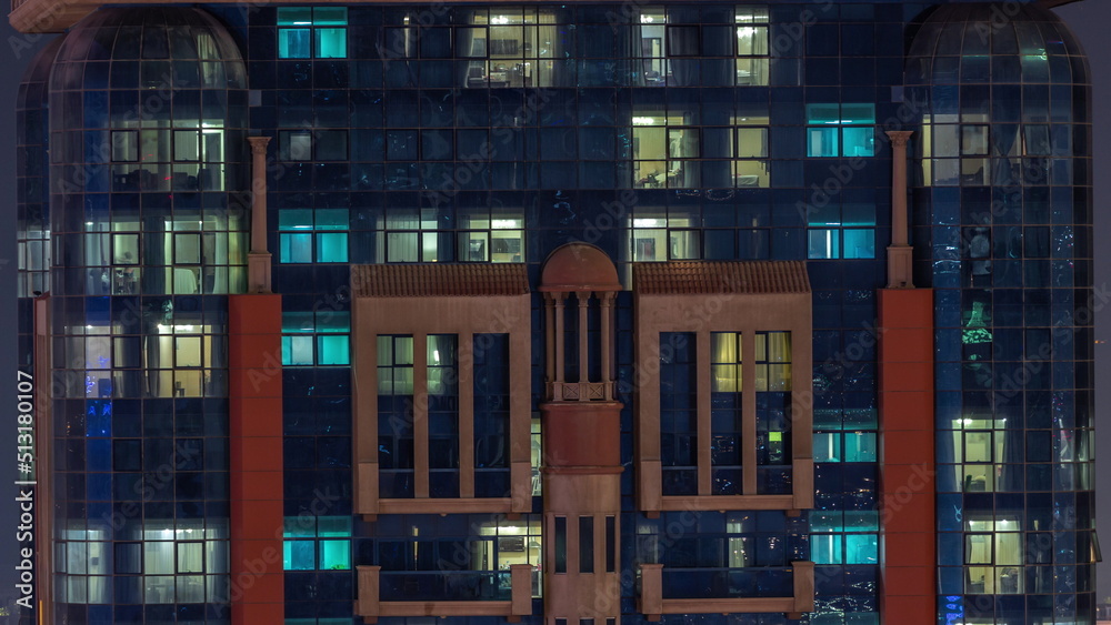 Night aerial view of apartment building glass window facade with ...