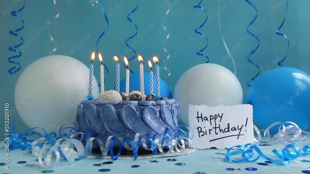 Blue birthday cake with candles and happy birthday lettering on card ...
