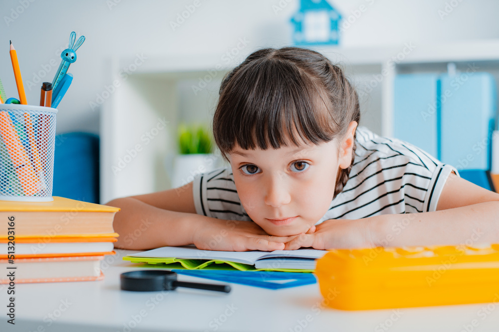 Smart concentrated small 7s years Caucasian girl child sit desk home ...