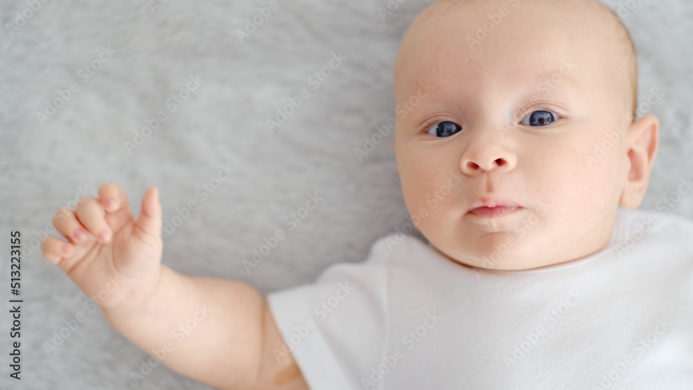 Child's face of a Happy newborn baby looking to camera. Healthy newborn ...