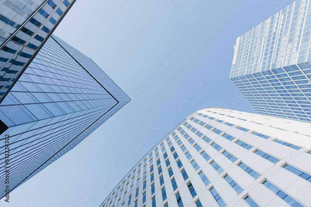 The view of the sky between three skyscrapers at noon. Modern office ...