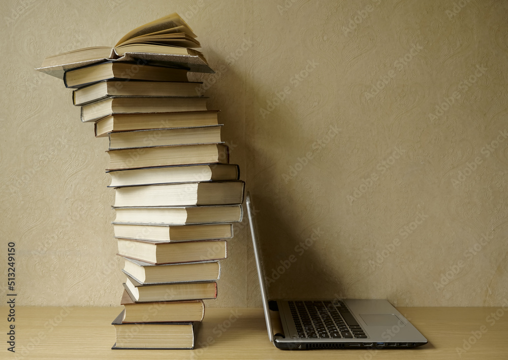 laptop Computer with empty black screen and stack of Books. opened book ...