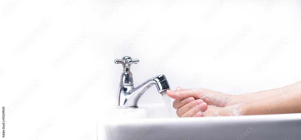 Woman washing hand with soap foam and tap water in bathroom. Hand clean ...