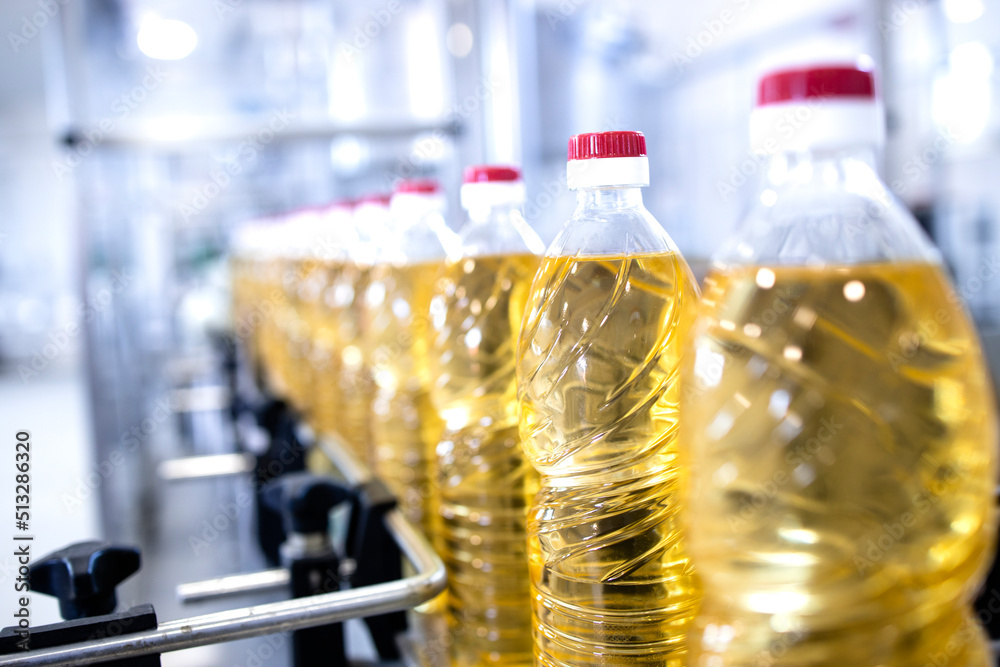 Vegetable oil production and bottles filled with sunflower oil being ...