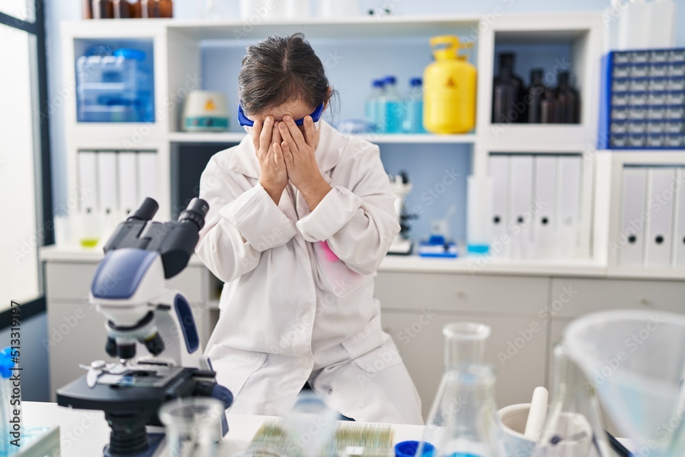 Hispanic girl with down syndrome working at scientist laboratory with ...