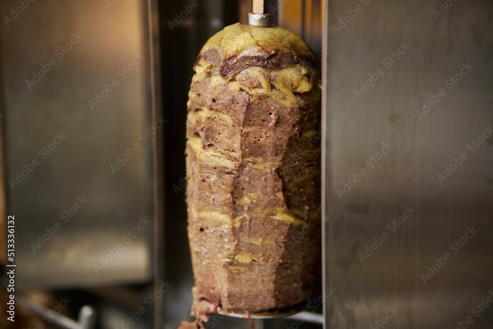 shawarma on a spit. Doner kebab on a rotating vertical spit ...