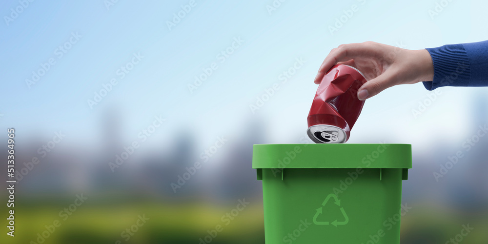 Woman putting a can in the trash bin Stock Photo | Adobe Stock