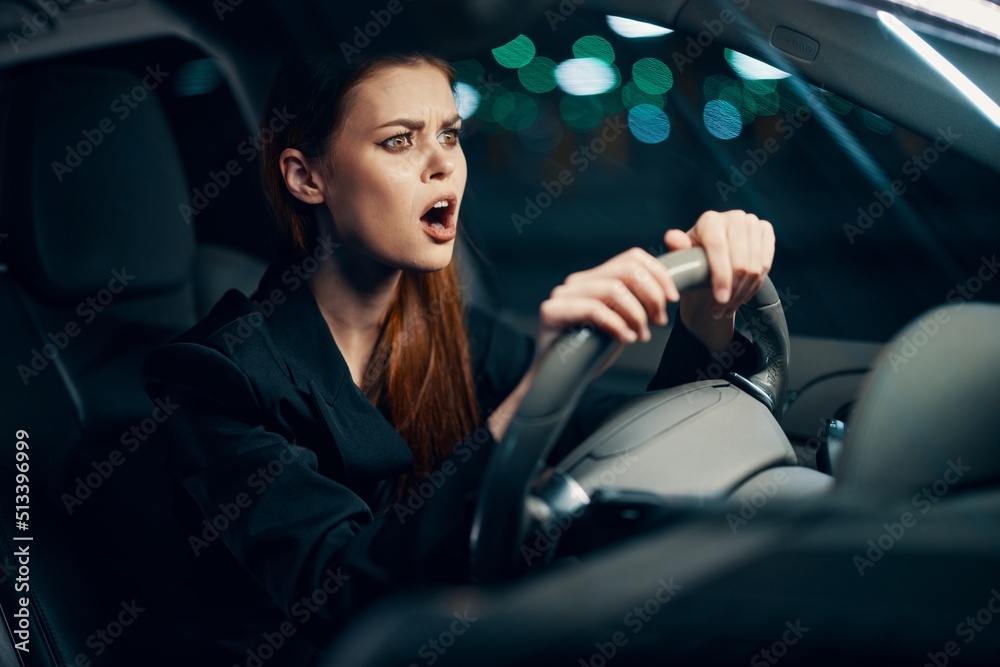 a surprised, shocked woman is sitting behind the wheel of a car with ...