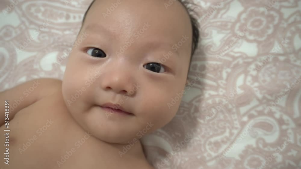 Close up and rotate view baby face at bed. Family, childhood concept ...