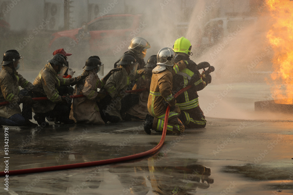 Firefighters using Twirl water fog type fire extinguisher to fighting ...