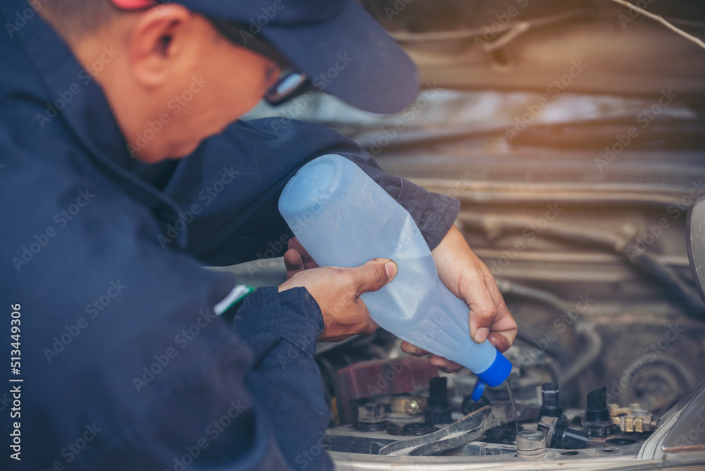 Car Mechanic man hands pouring Deionized purified Distilled water for ...