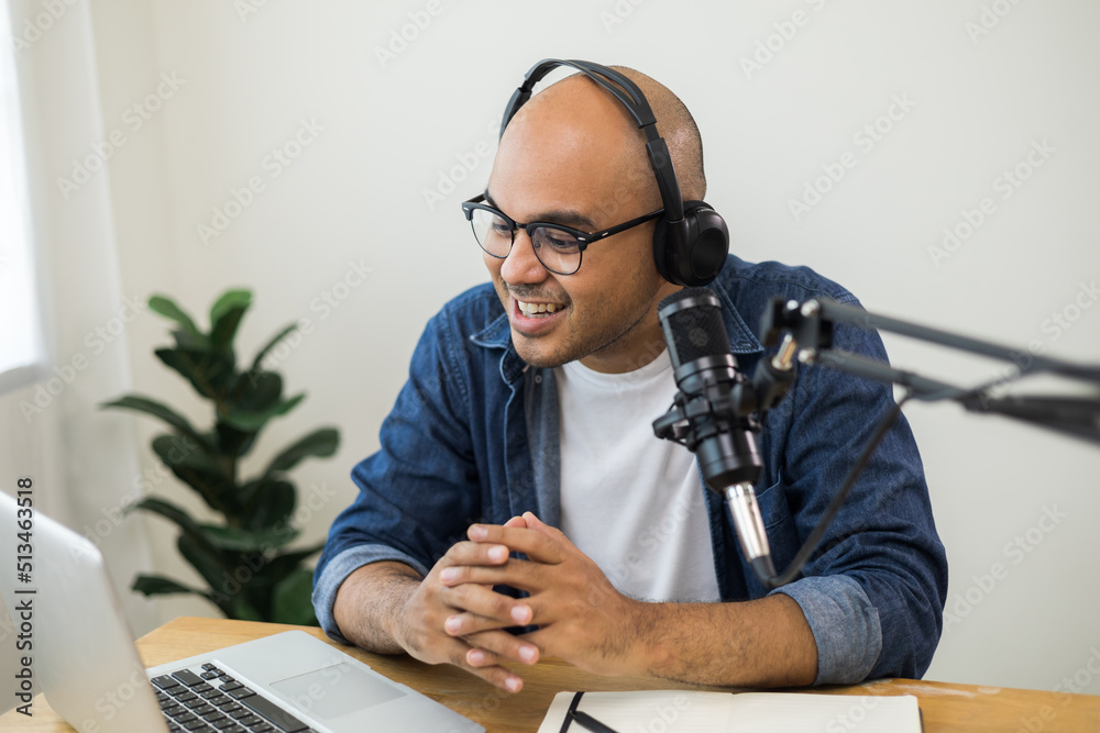 Content creator asia man host streaming his a podcast on laptop with ...
