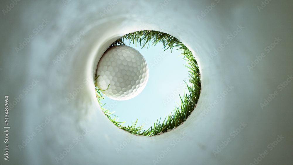 Detail of golf ball, view from inside the hole. Stock Photo | Adobe Stock