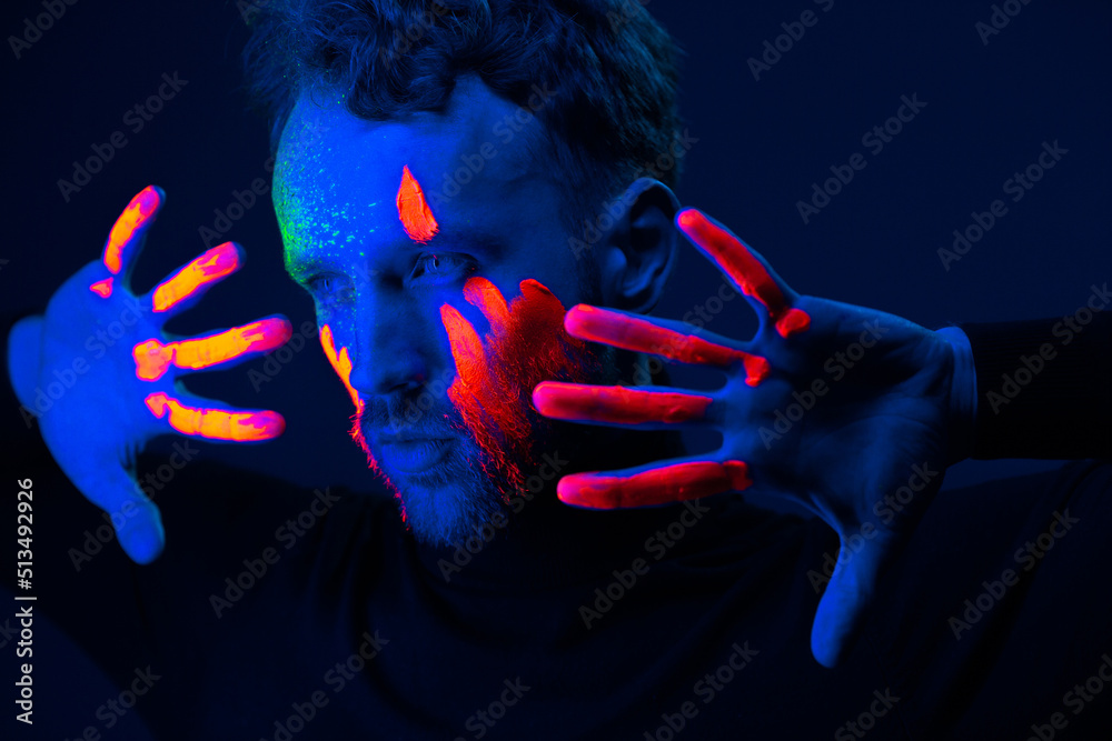 Caucasian male model with blacklight paint. Stock Photo | Adobe Stock