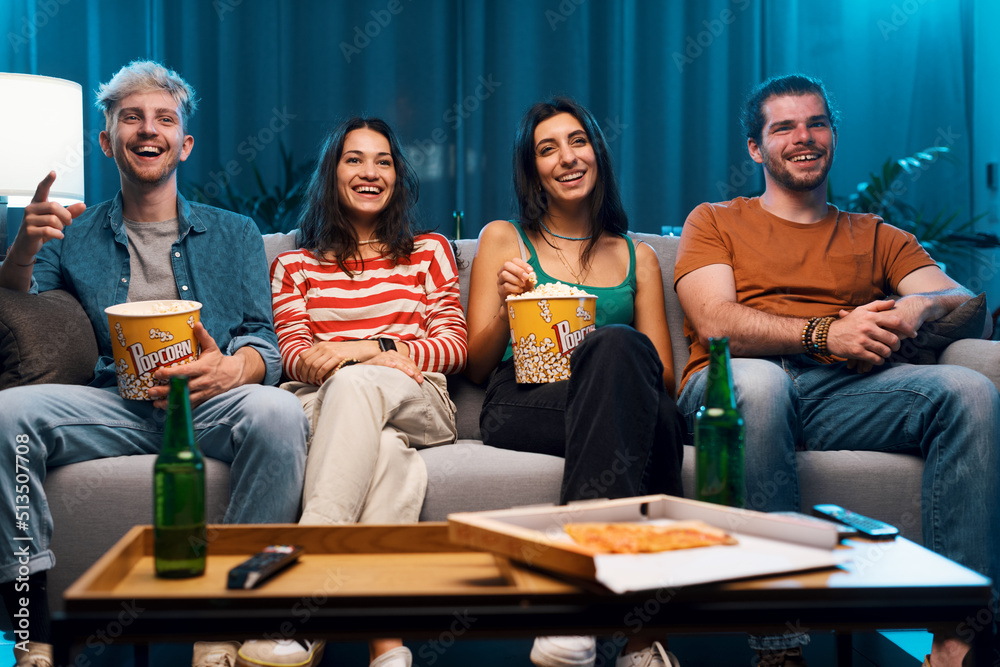 Happy friends watching movies together Stock Photo | Adobe Stock
