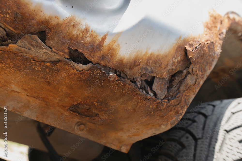 Deep rust on the body of a gray old car. Rust and corrosion hole on old ...